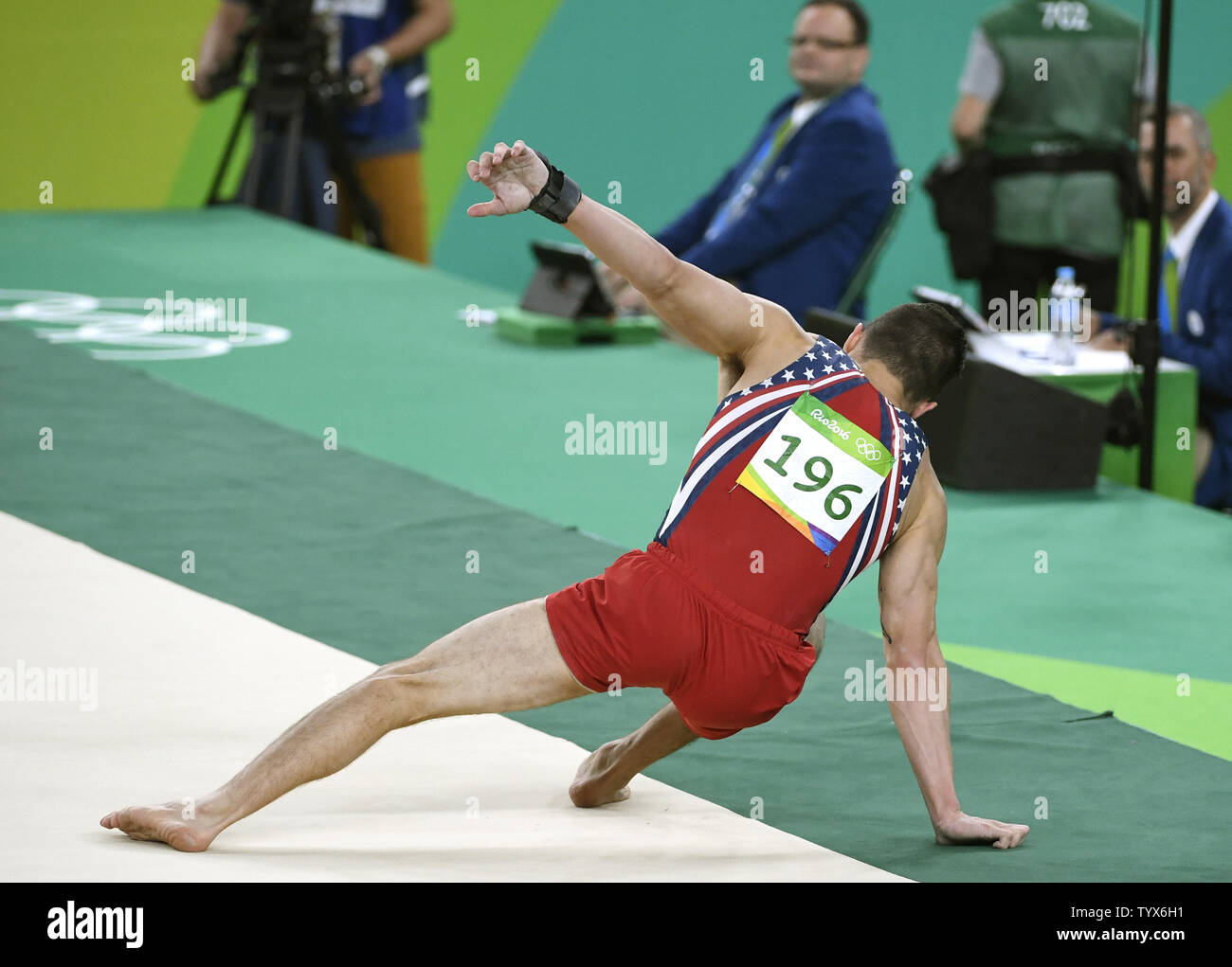 American gymnast Alexander Naddour stumbles across the boundary as he ...