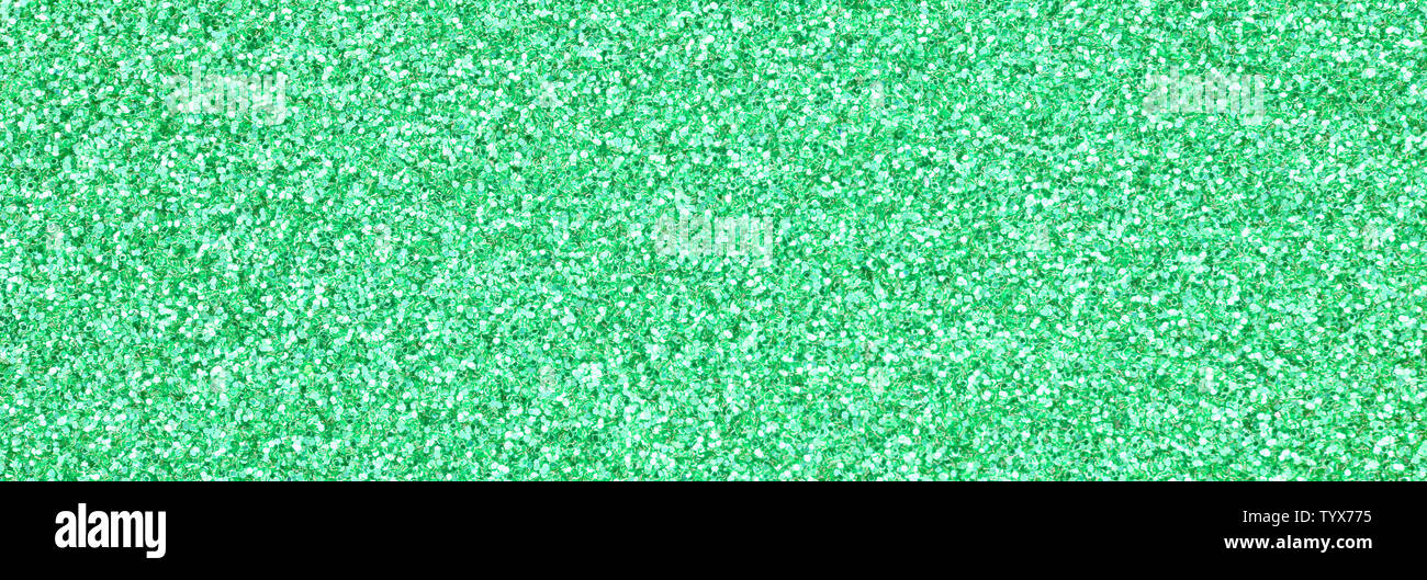 A huge amount of green decorative sequins. Background image with shiny ...