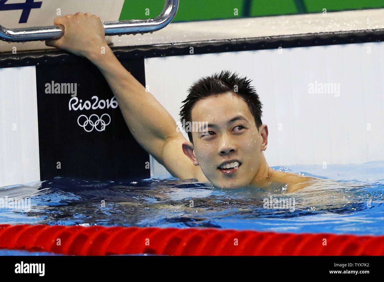 Geoffrey Cheah of Hong Kong smiles as he looks up at the clock after ...