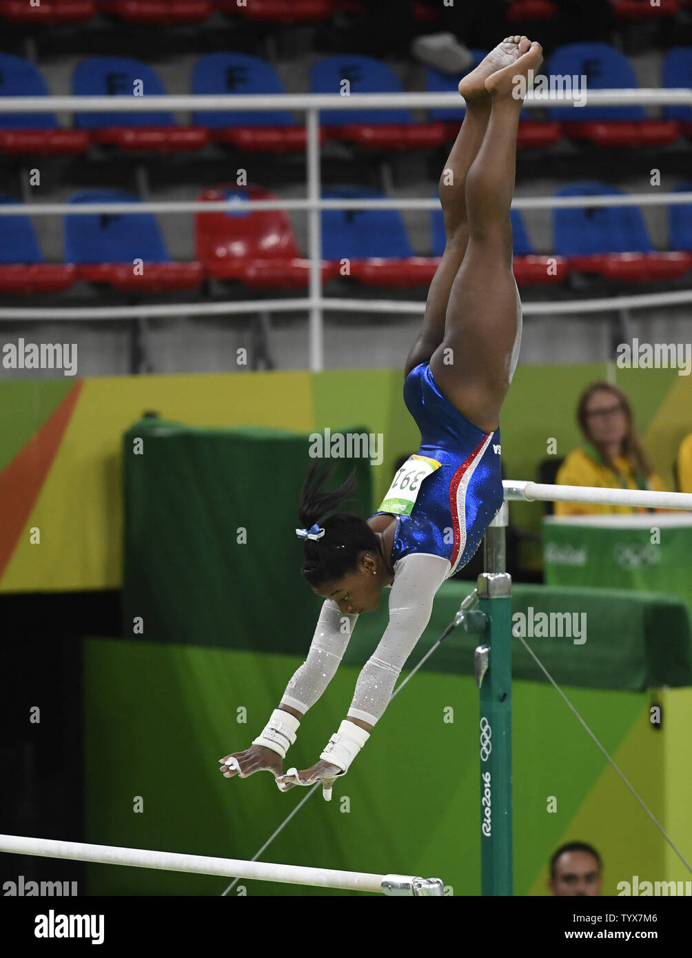 Simone Biles of the United States competes on the uneven bars in the ...