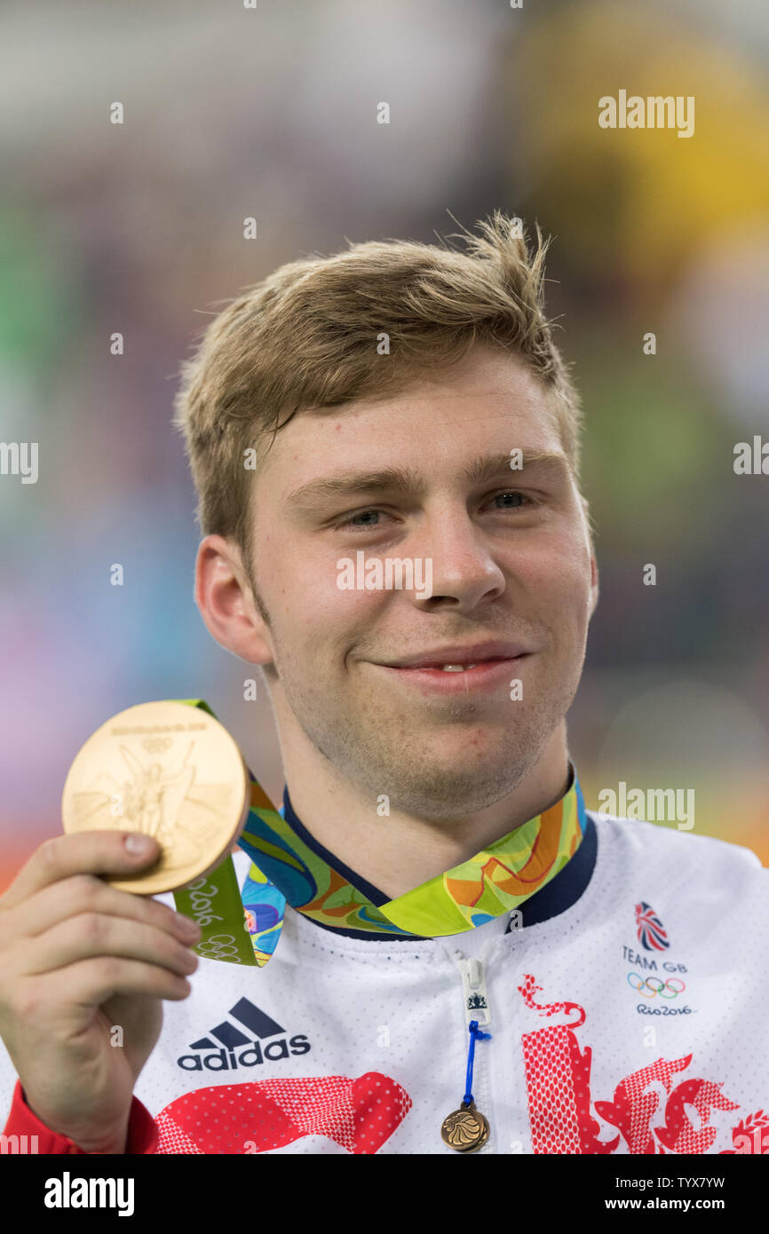 Cyclist Callum Skinner of Great Britain shows his gold medal following ...