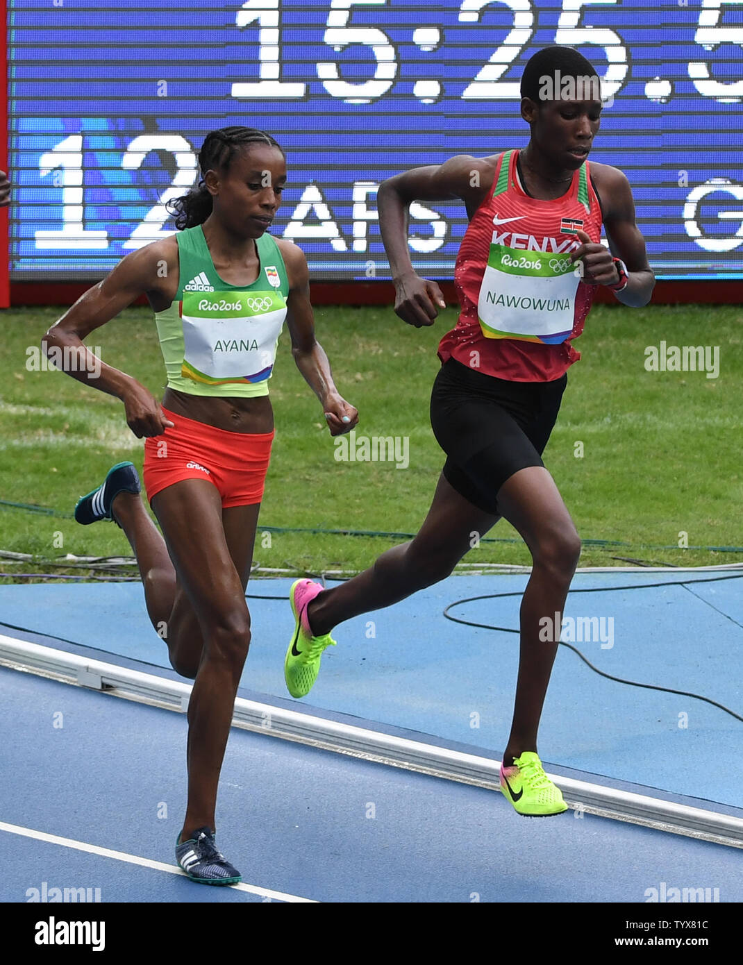 Almaz Ayana of Ethiopia passes Alice Aprot Nawowuna of Kenya on the ...