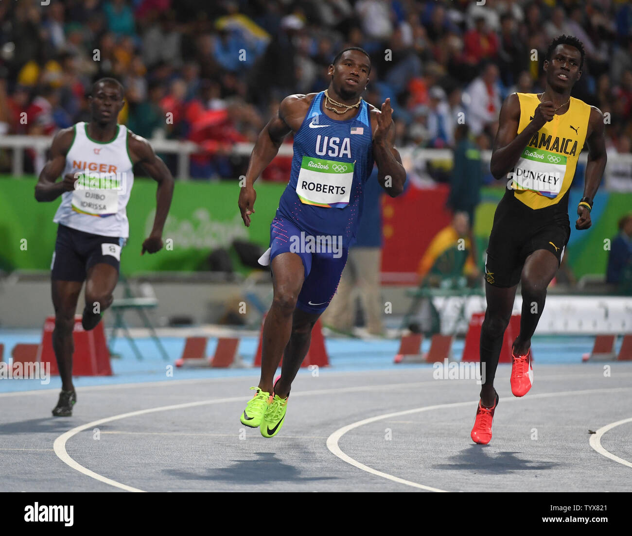 USA's Gil Roberts (C) runs in the first round of heats for the Men's ...
