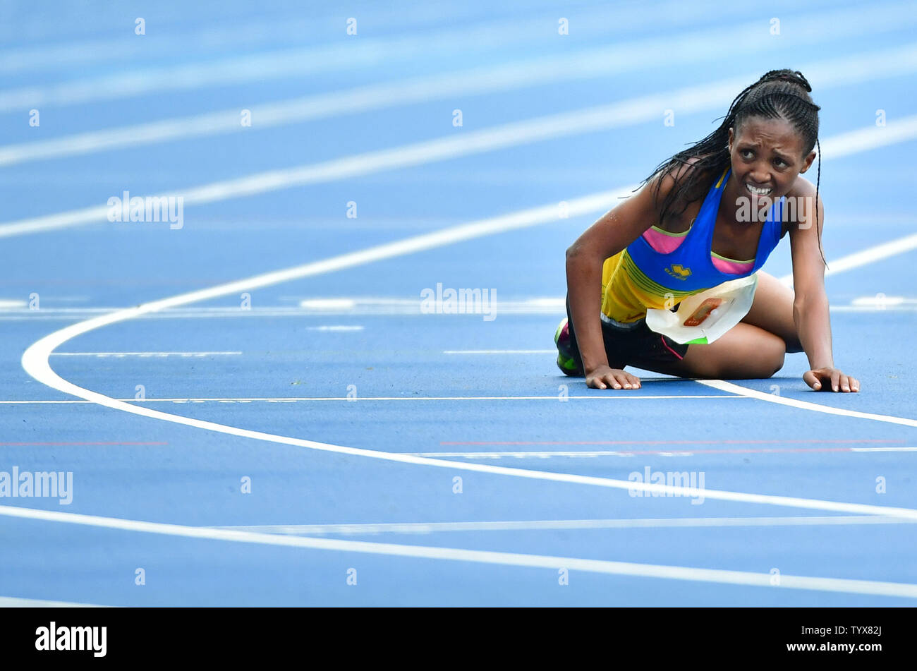 Salome Nyirarukundo of Rwanda falls on the track during the Women's 10 ...