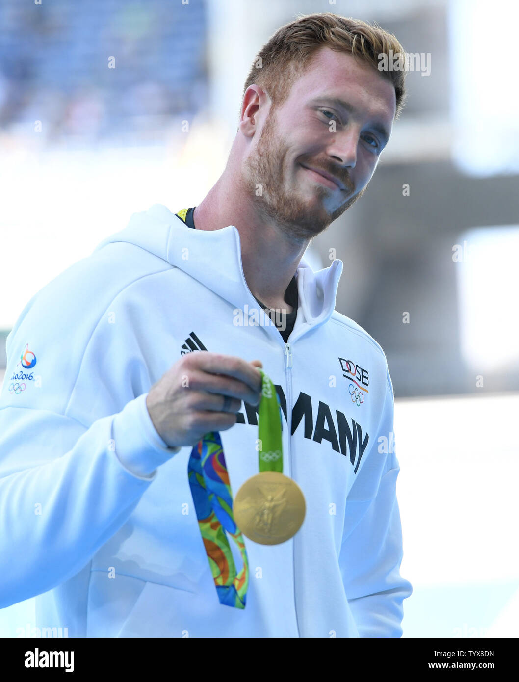 Christoph Harting of Germany hows off his gold medal for the Discus ...