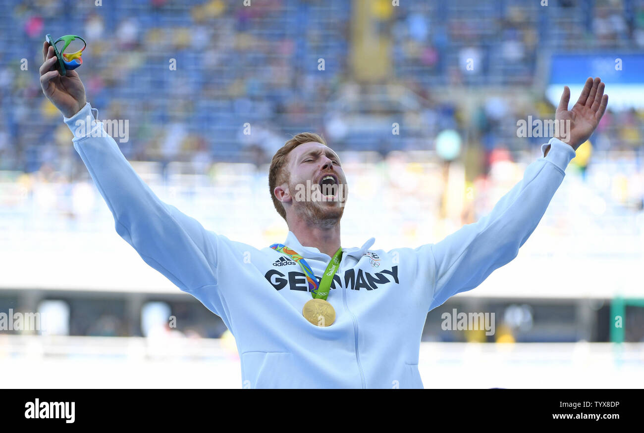 Christoph Harting of Germany yells from atop the medal stand after ...