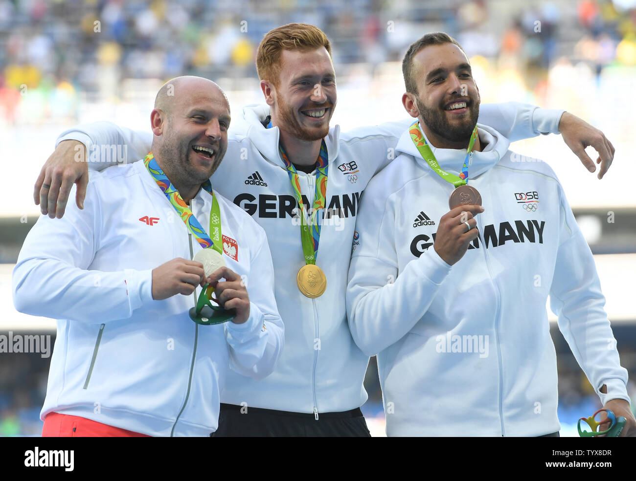 Christoph Harting of Germany (C) poses with silver medal winner Piotr ...