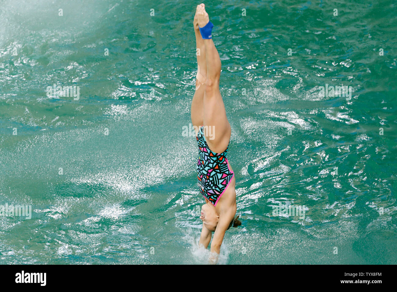 A diver practices at the green tinted diving pool in the Maria Lenk ...