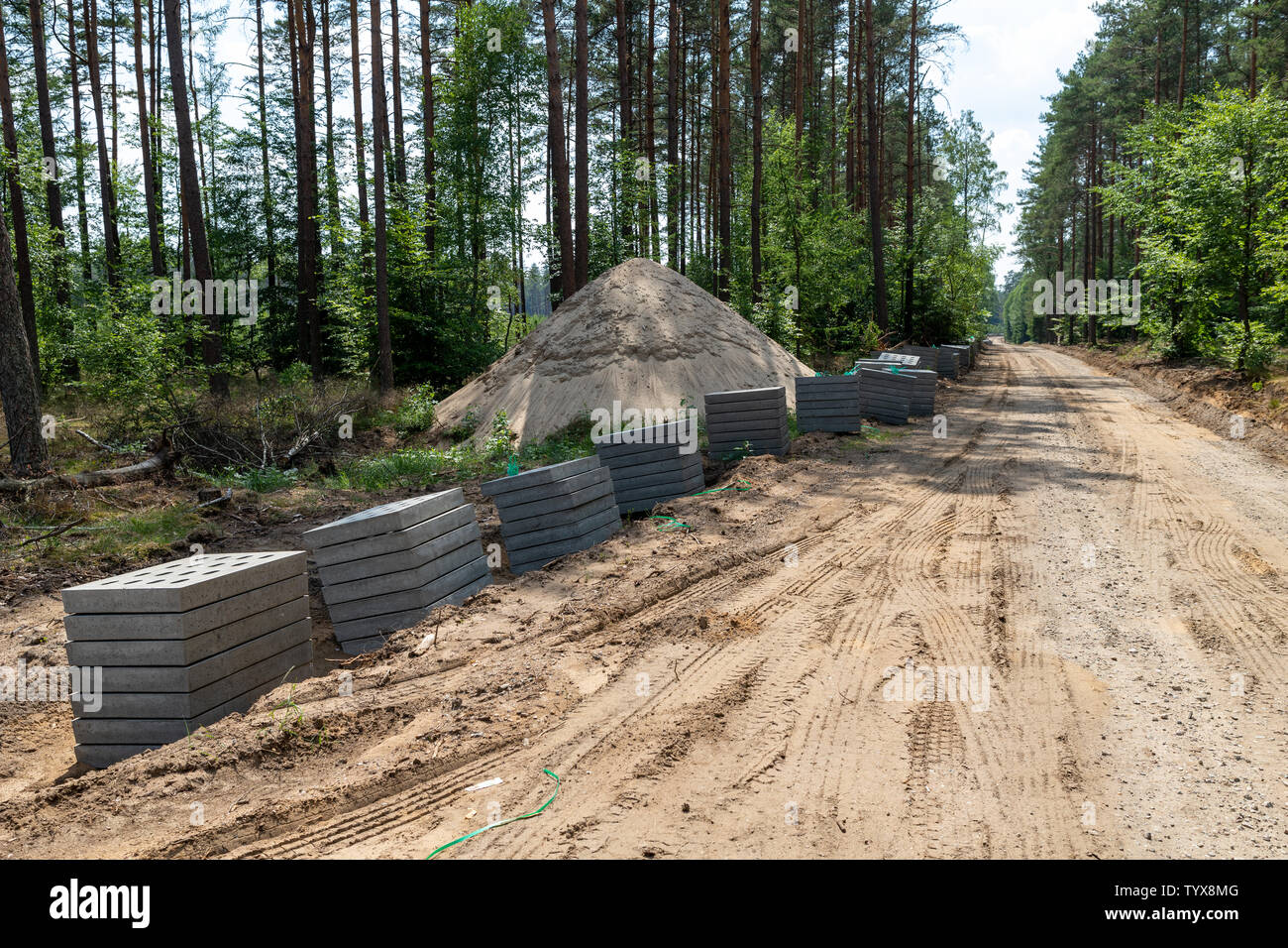 Construction of a new road from concrete slabs. Setting a new route in ...