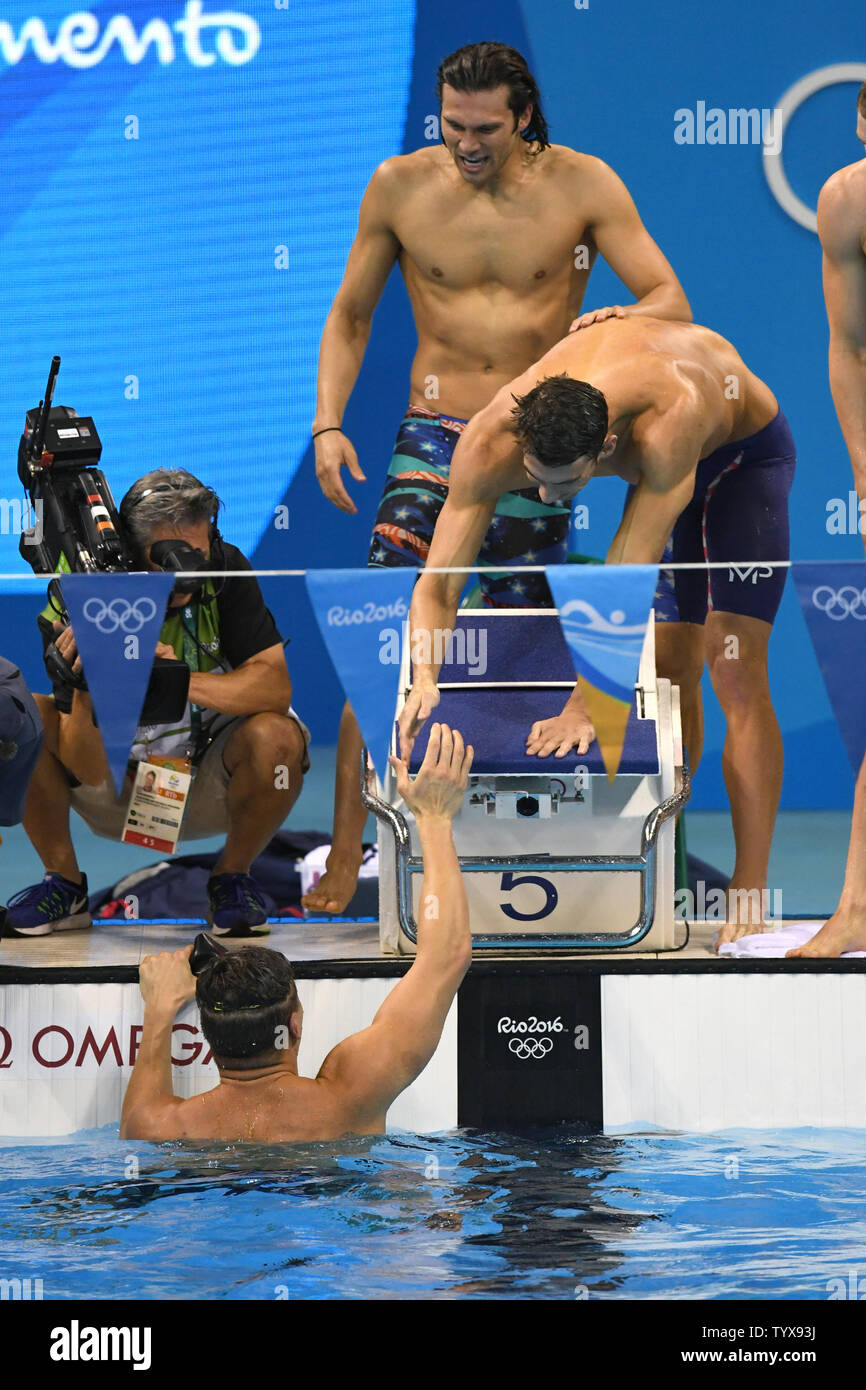USA's Michael Phelps reaches down to congratulate teammate Nathan ...