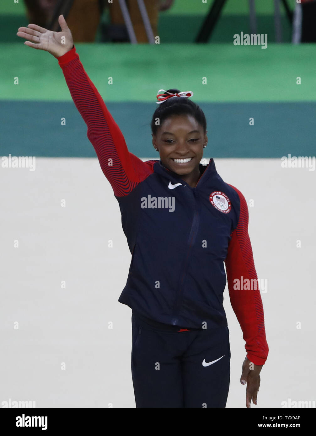 USA's Simone Biles waves from the winners stand after taking gold in ...