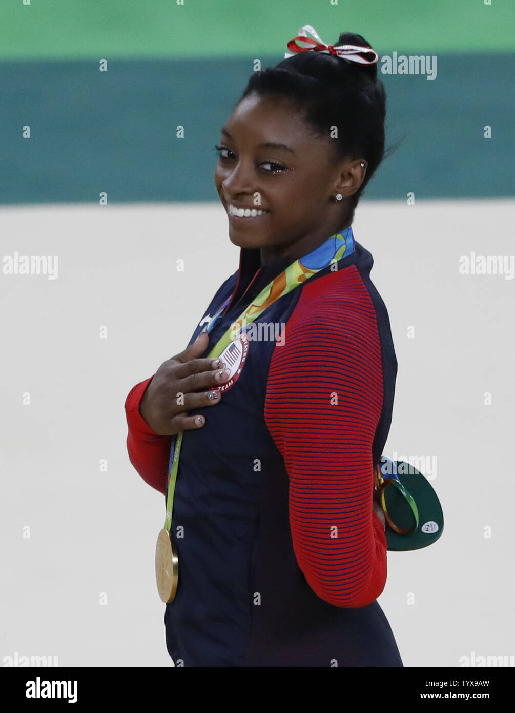 USA's Simone Biles smiles during the National Anthem after taking gold ...