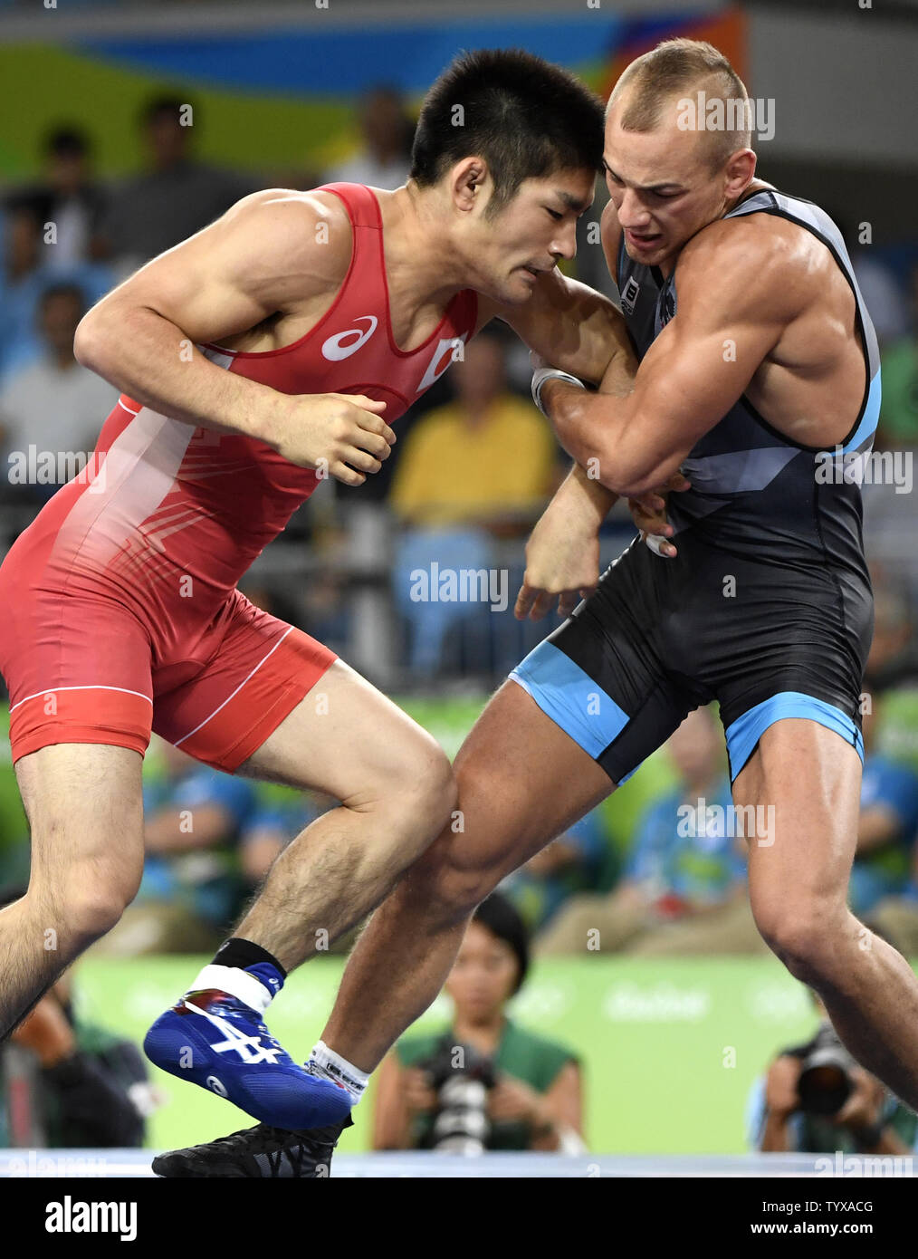 Japan's Tomohiro Inoue (L) and Germany's Frank Staebler each look for ...