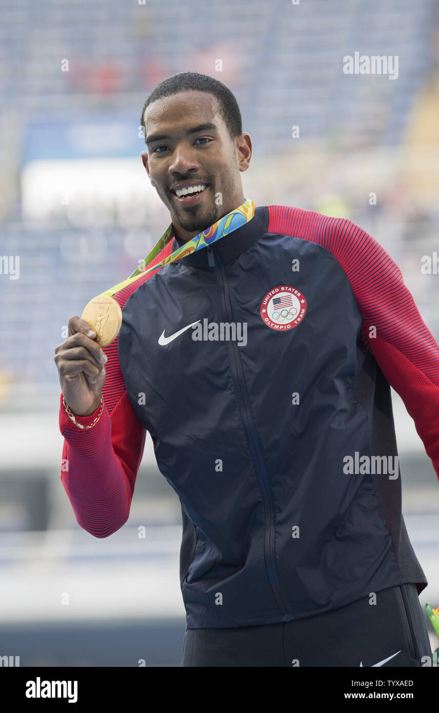 Christian Taylor of the USA, shows his gold medal during the awards ...