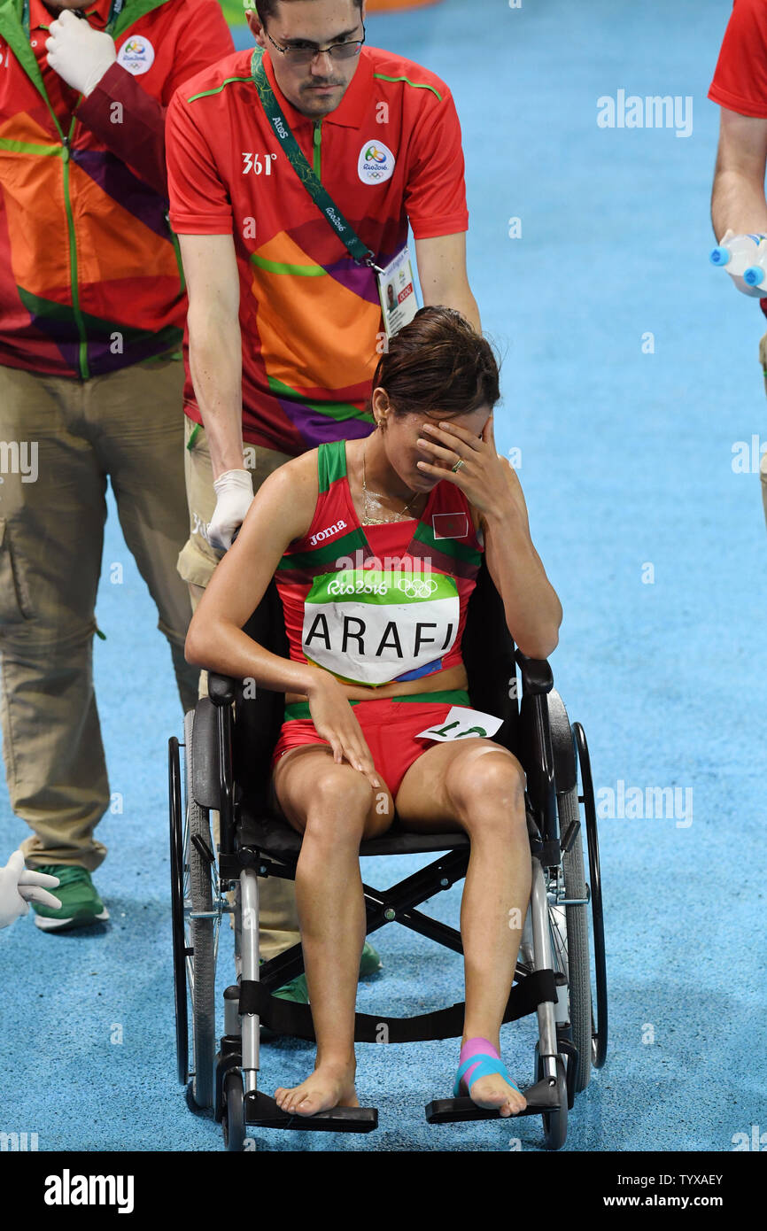 Rababe Arafi of Morocco is taken from the track in a wheelchair ...