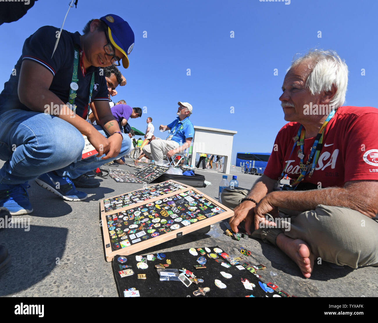 Pin dealers trade pins with media from around the world in front of the ...