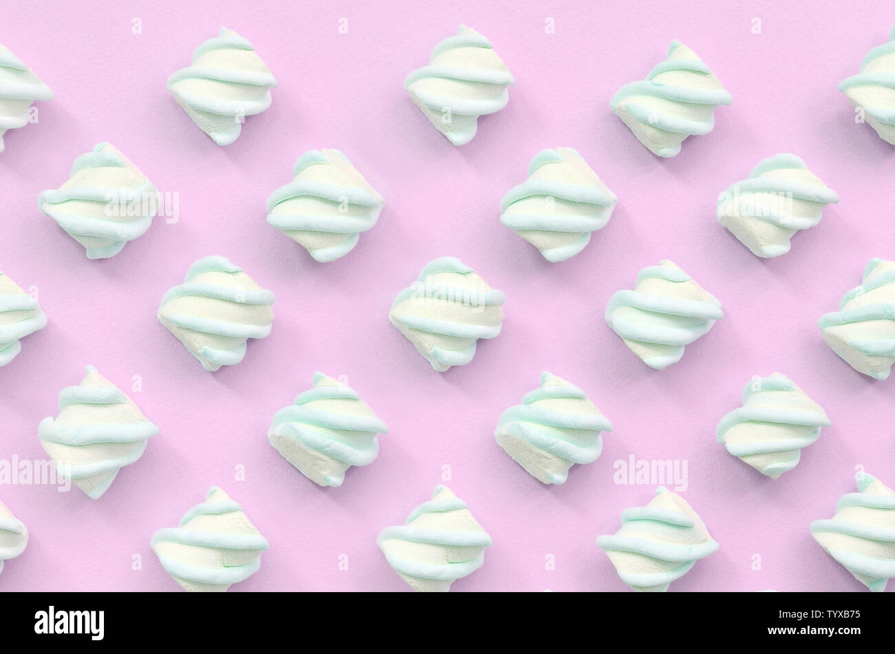 Colorful marshmallow laid out on pink paper background. pastel creative ...