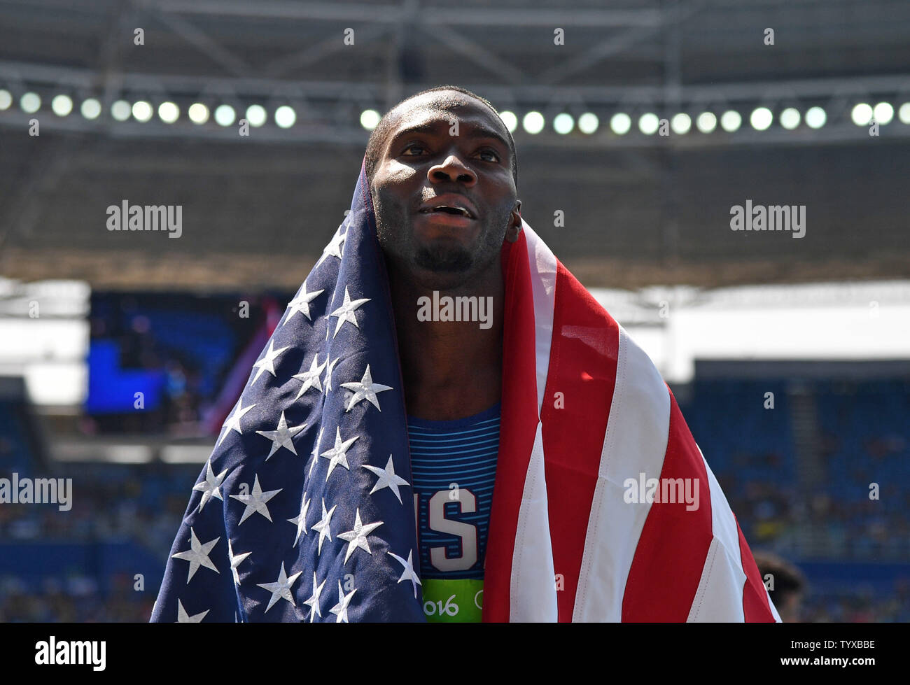Kerron Clement of the United States wears an American flag after ...