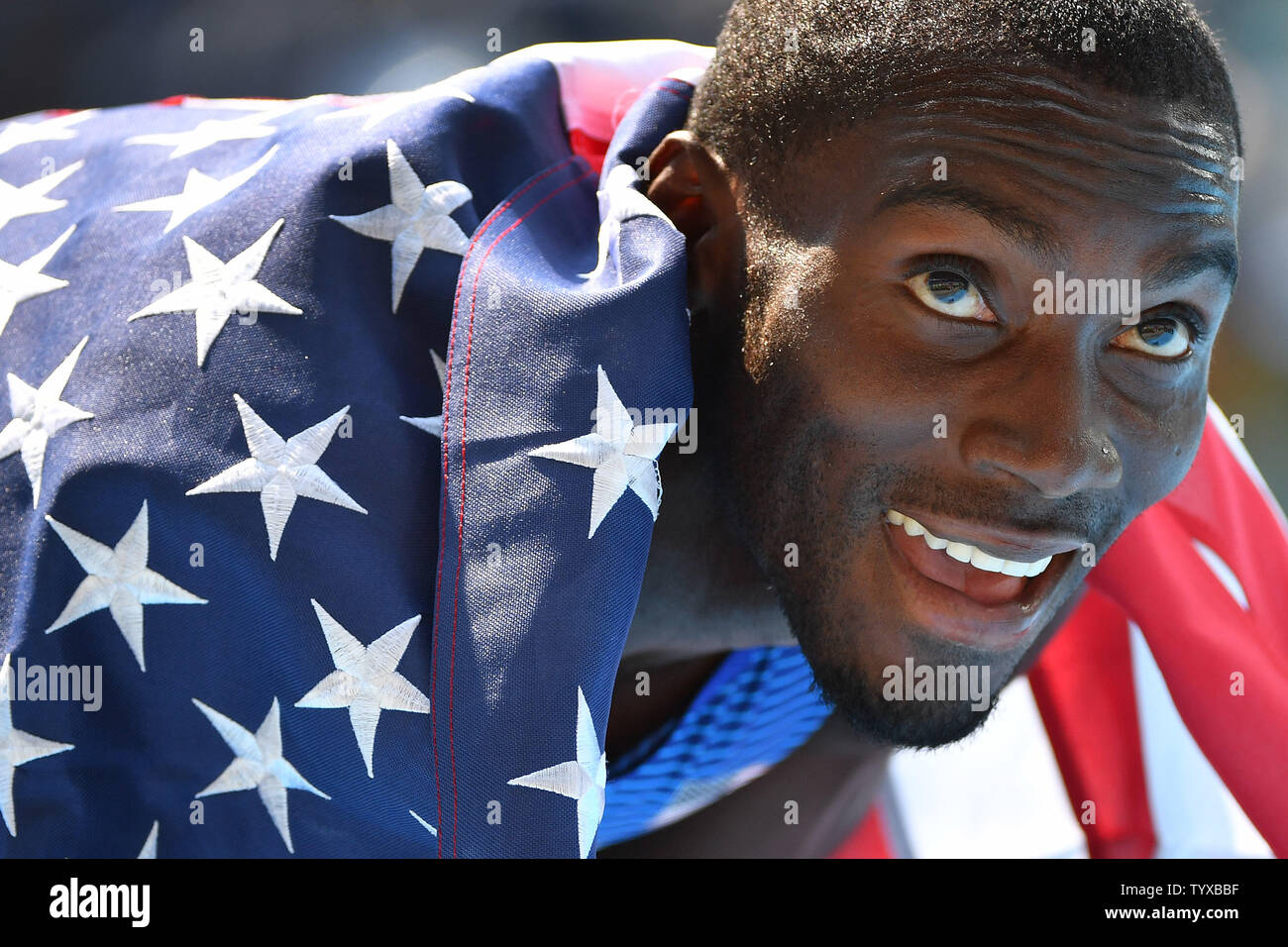 Kerron Clement of the United States wears an American flag after ...