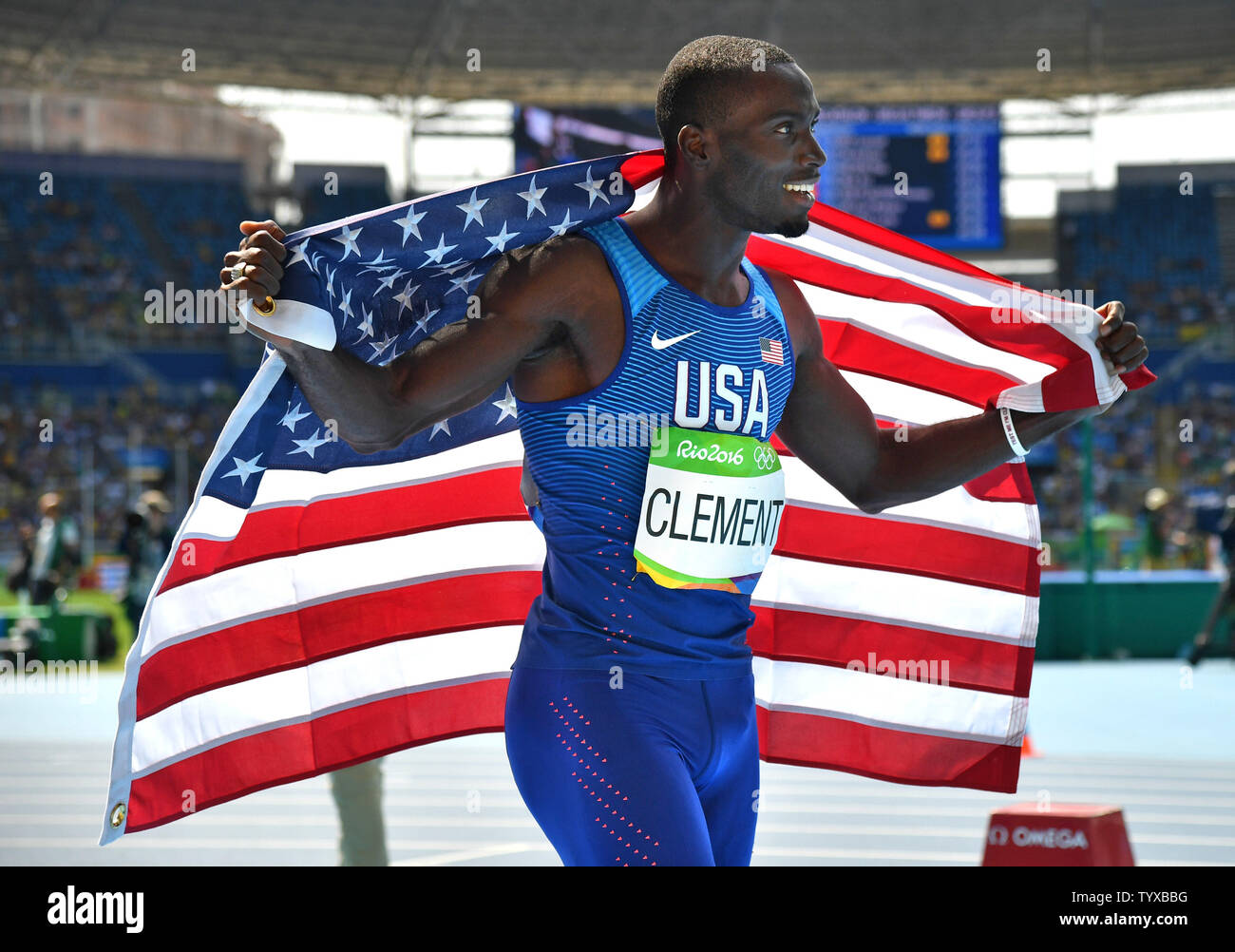 Kerron Clement of the United States holds an American flag after ...