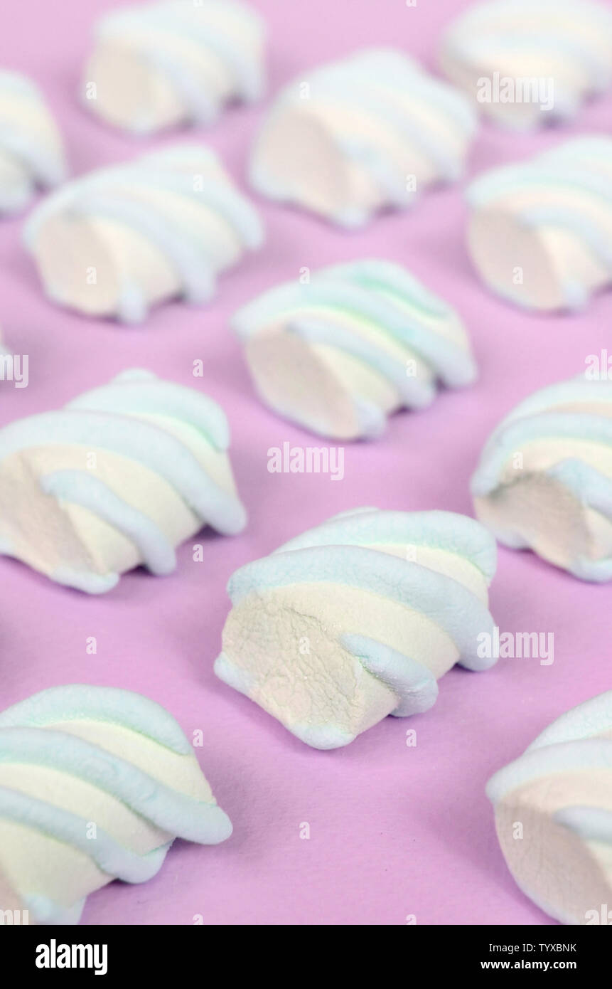 Colorful marshmallow laid out on pink paper background. pastel creative ...