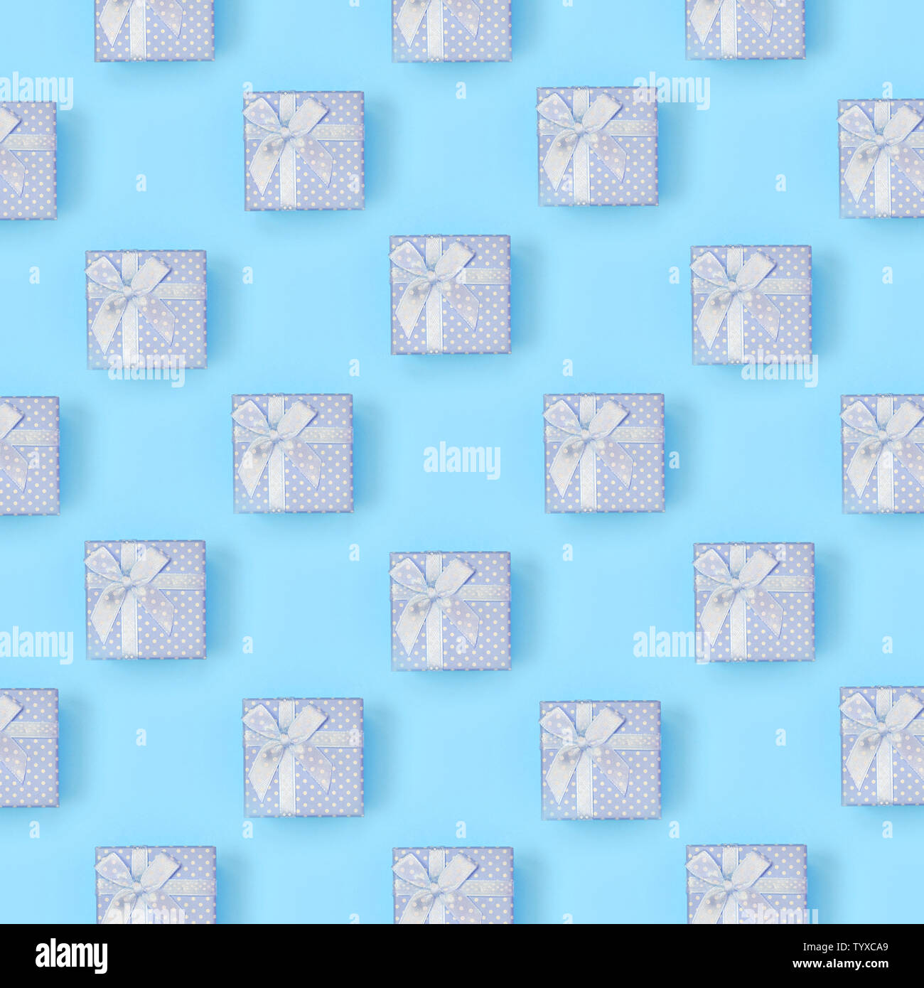 A lot of blue gift boxes lies on texture background of fashion pastel ...