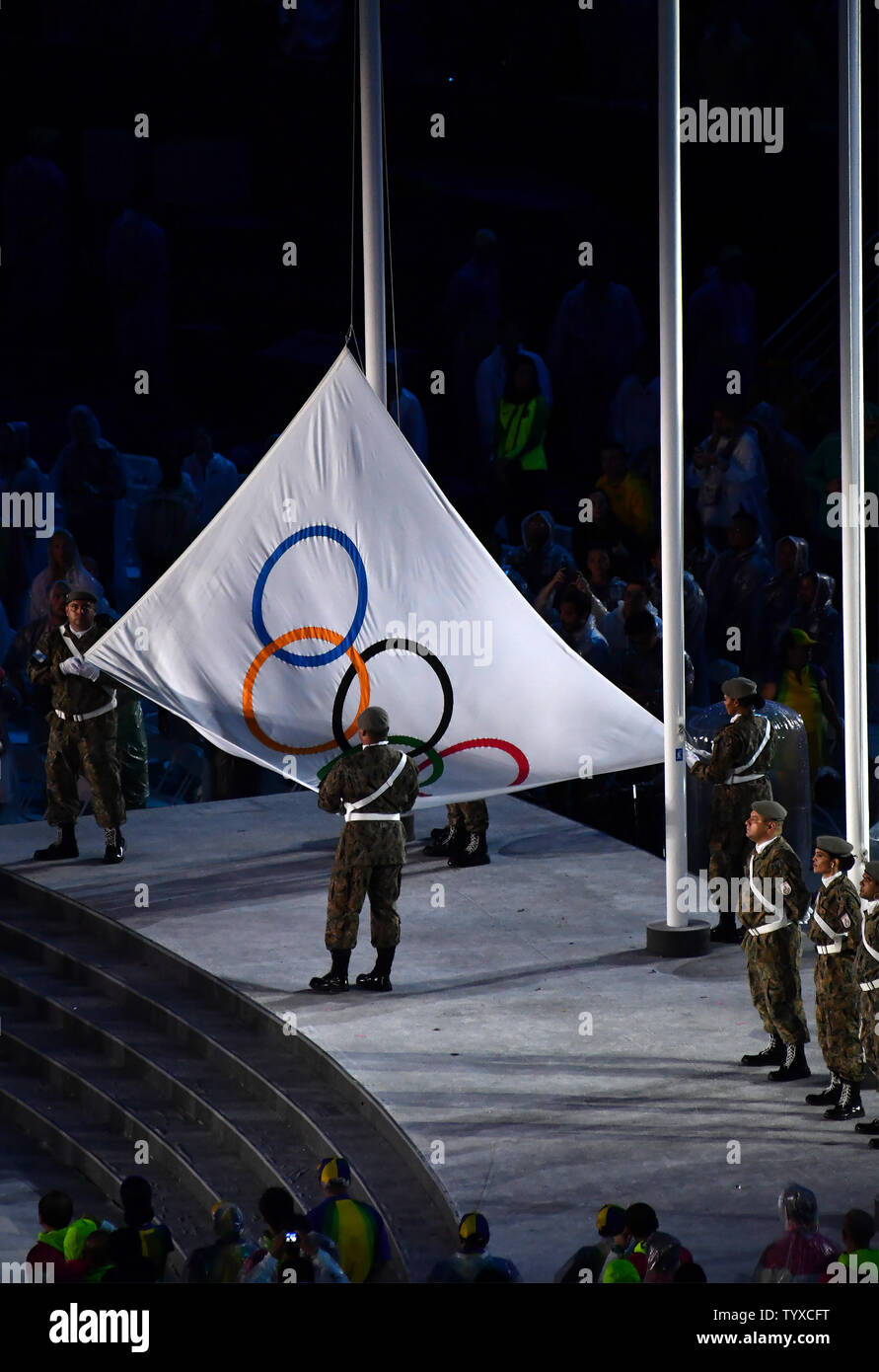 The Olympic flag is carried to the exchange podium during the Closing ...