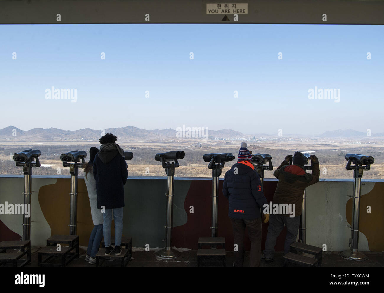Tourist use binoculars to look into North Korea from the Dora ...