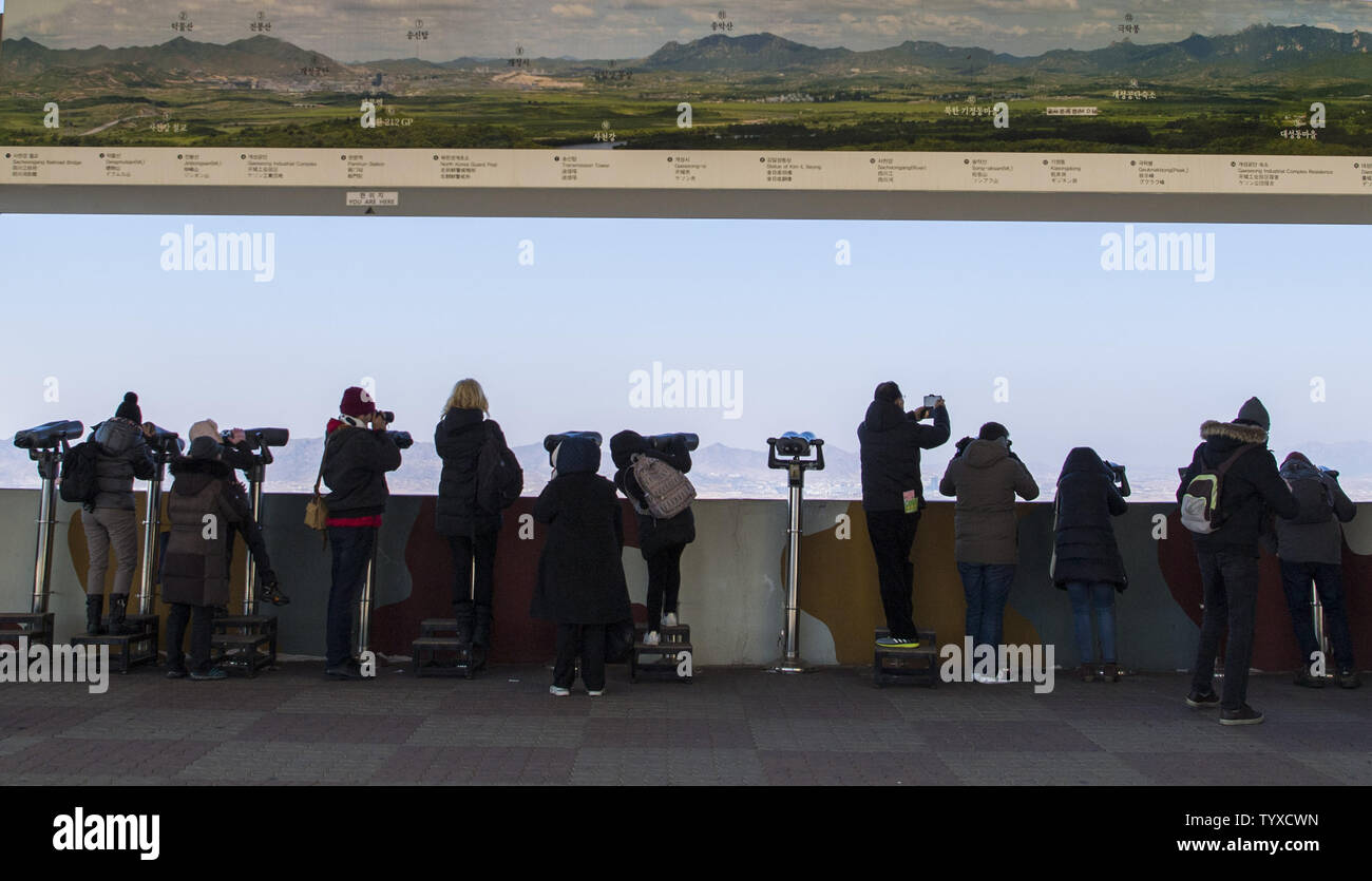 Tourist use binoculars to look into North Korea from the Dora ...