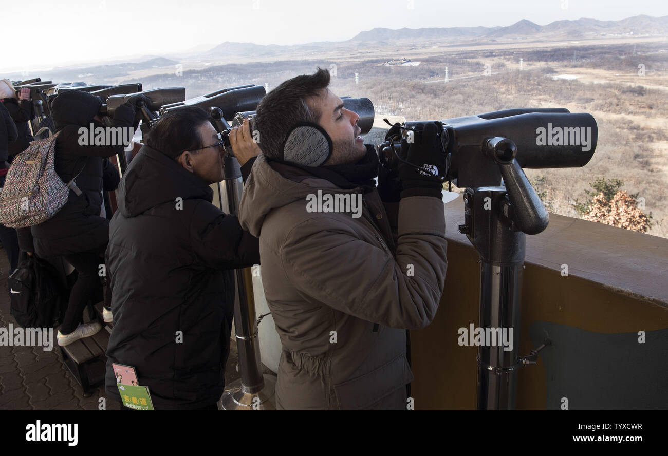 Tourist use binoculars to look into North Korea from the Dora ...