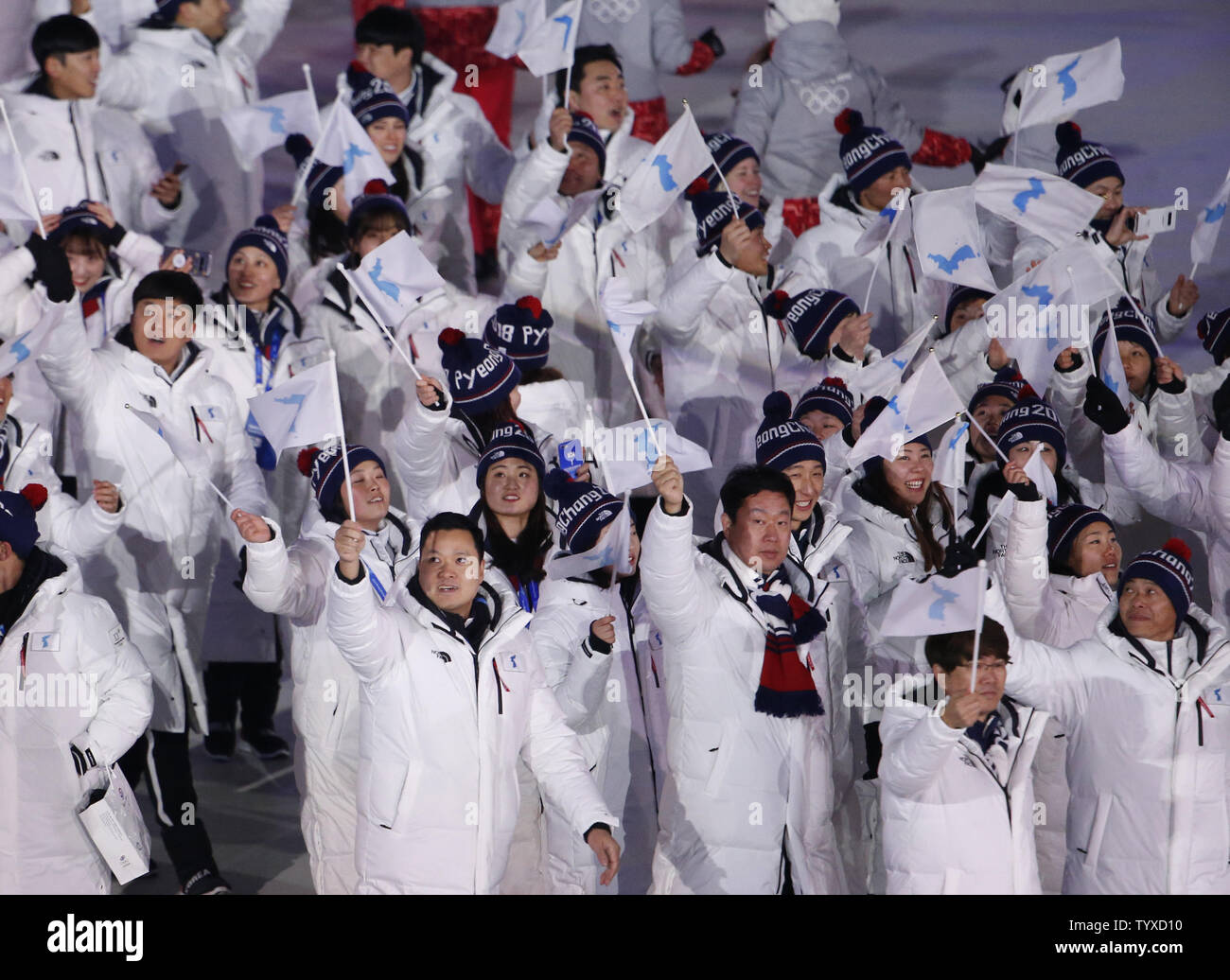 North and South Korean athletes walk together under one flag during the ...