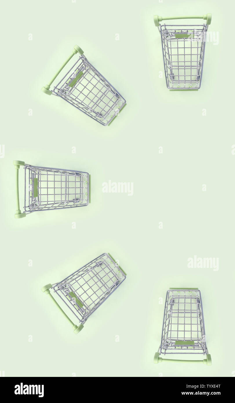 Pattern of many small shopping carts on a lime background. Minimalism ...