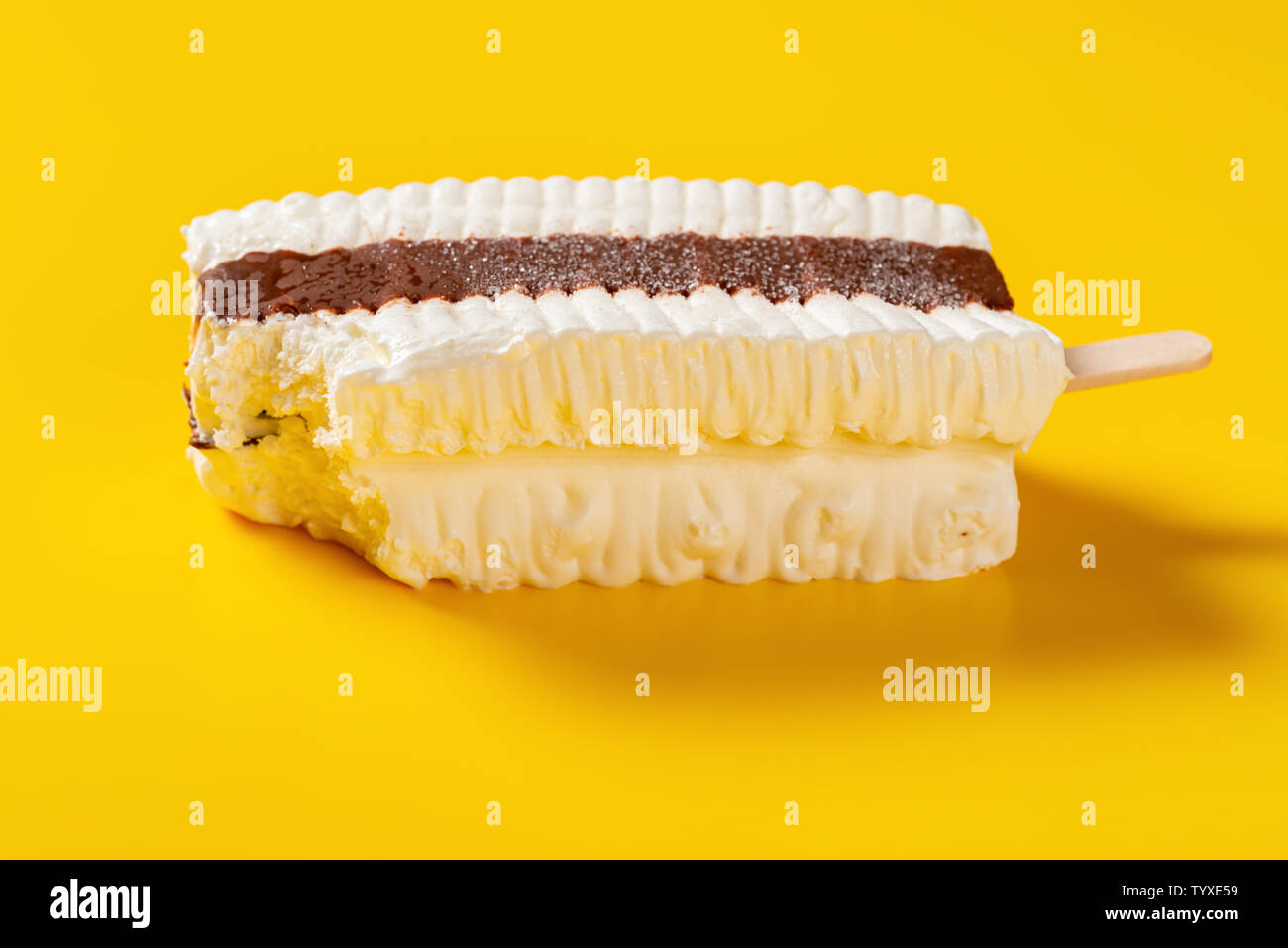 side view fresh chocolate and milkshake flavor popsicle with a bite on ...