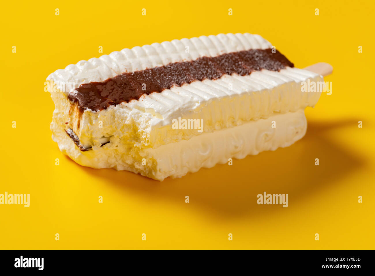 side view fresh chocolate and milkshake flavor popsicle with a bite on ...