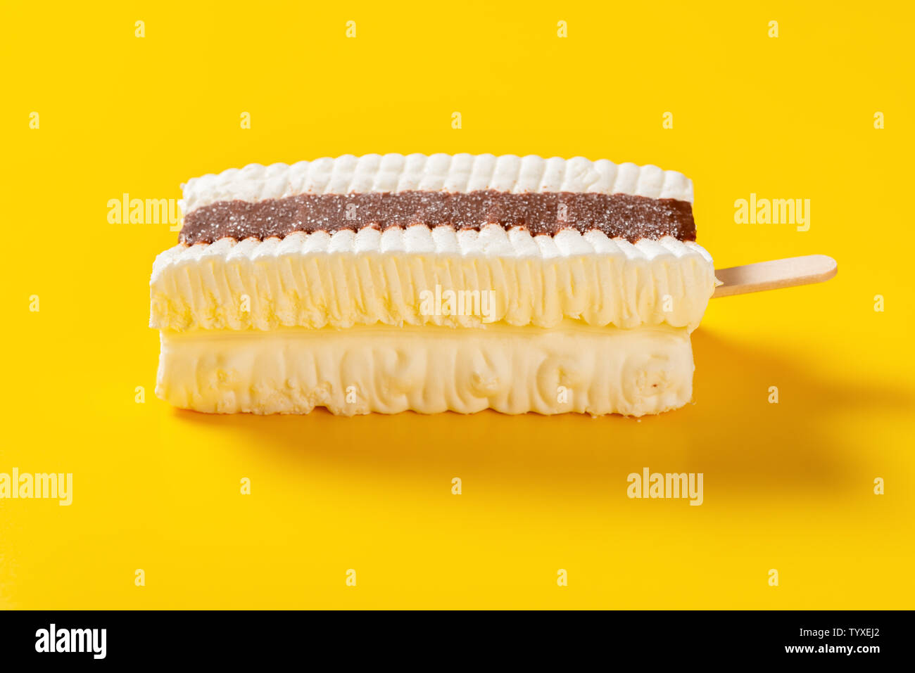 side view fresh chocolate and milkshake flavor popsicle on a yellow ...