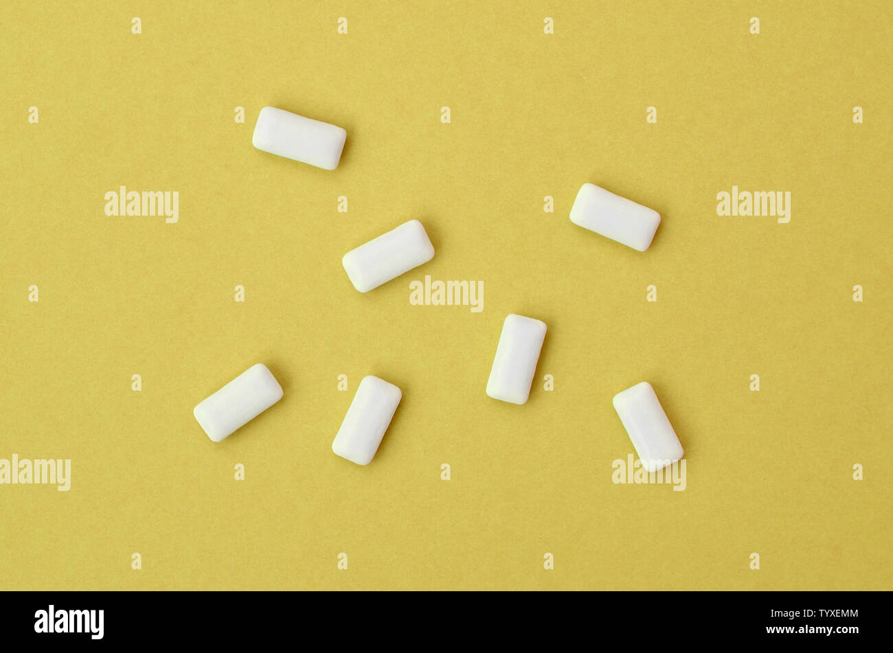 A few chewing gums lie on texture background of fashion pastel orange ...