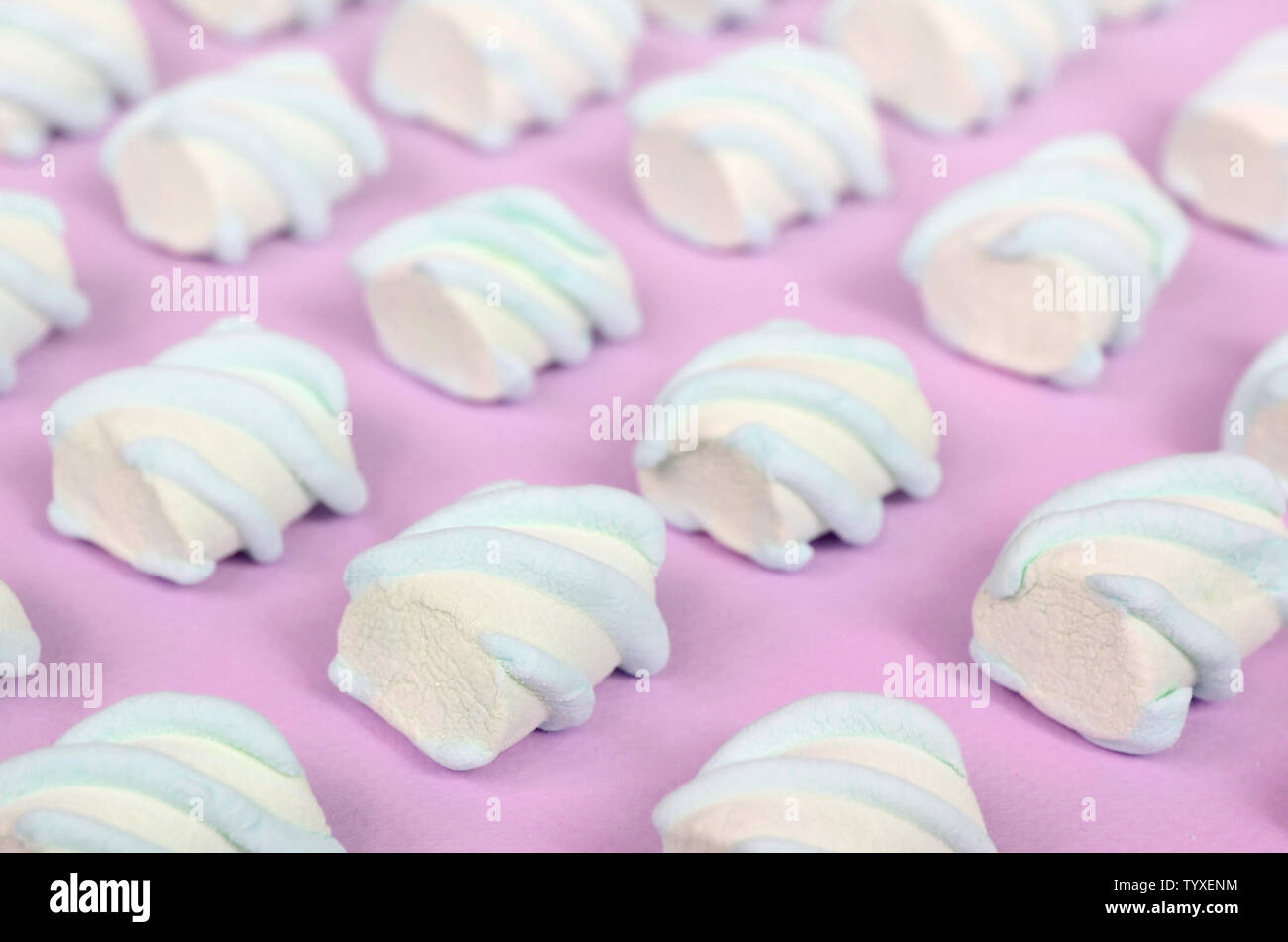 Colorful marshmallow laid out on pink paper background. pastel creative ...