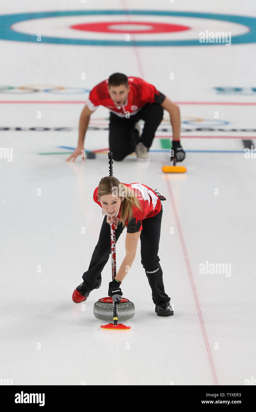 Kaitlyn Lawes of Canada sweeps as teammate John Morris instructs during ...