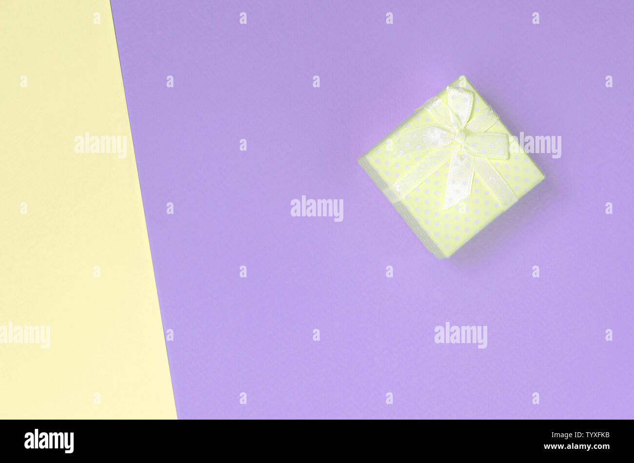 Small yellow gift box lie on texture background of fashion pastel ...