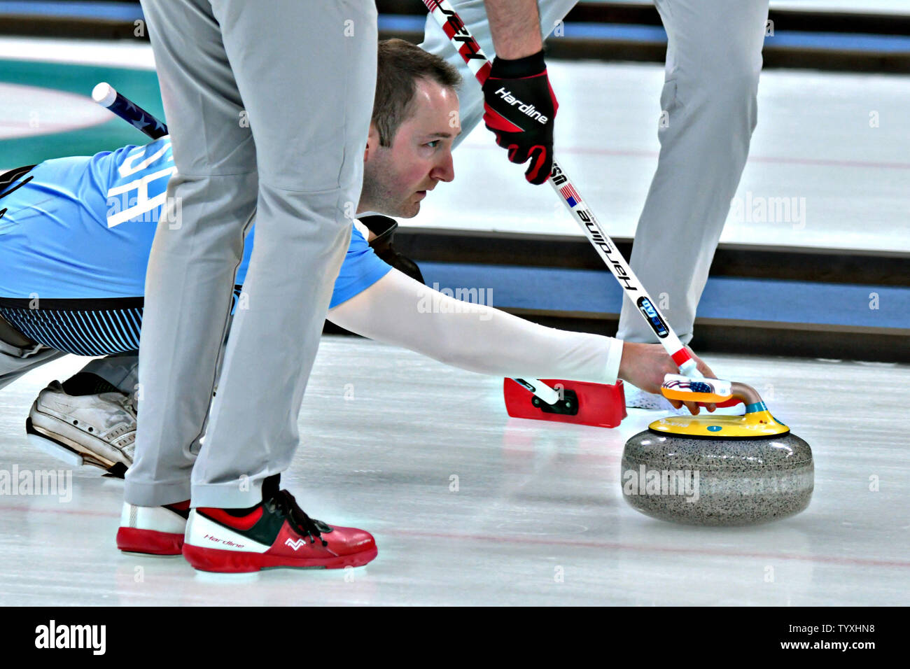 Tyler George of the United States pushes the stone down the sheet ...