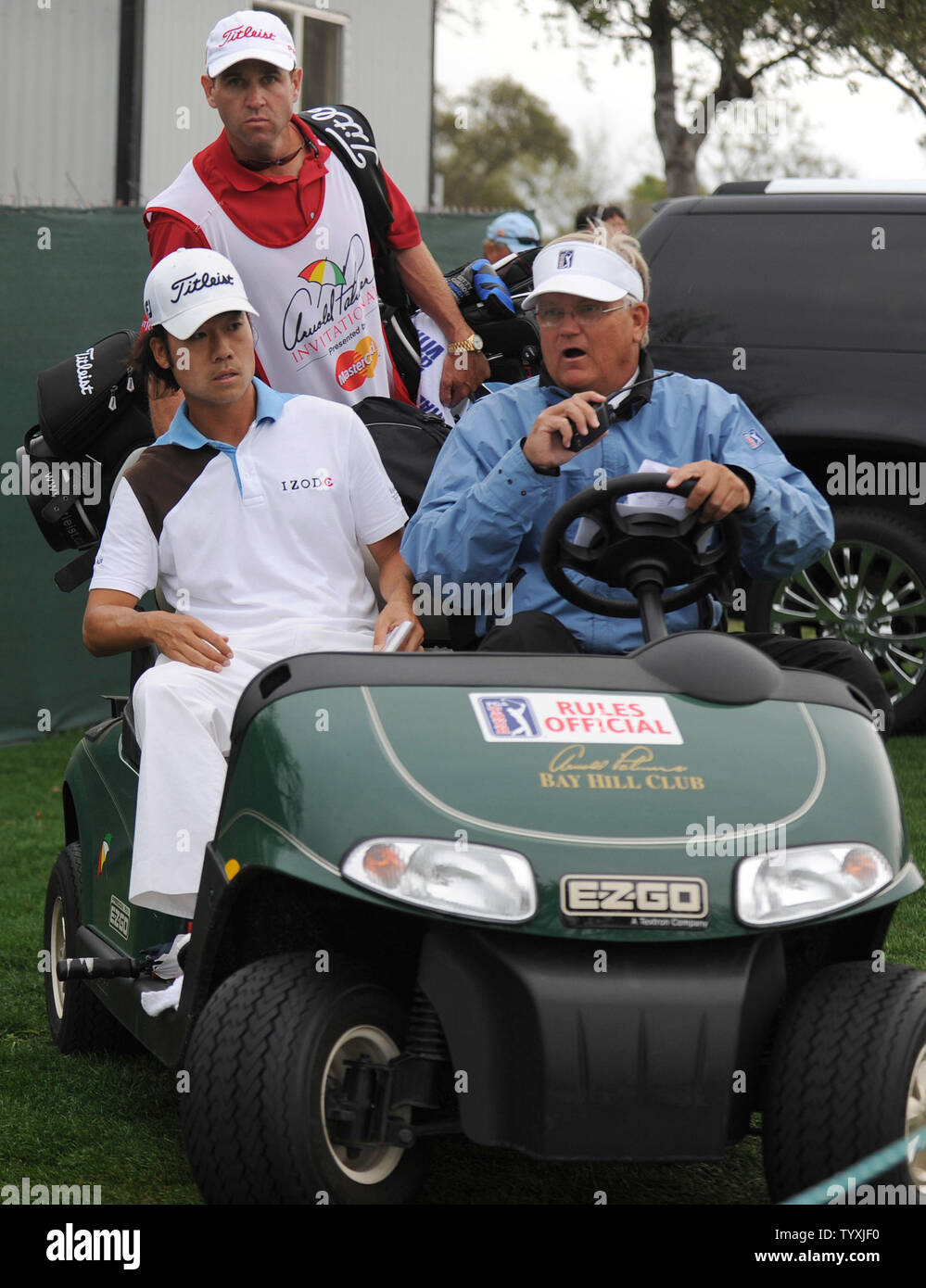 Kevin Na and his caddy are taken off the course following a lightning ...