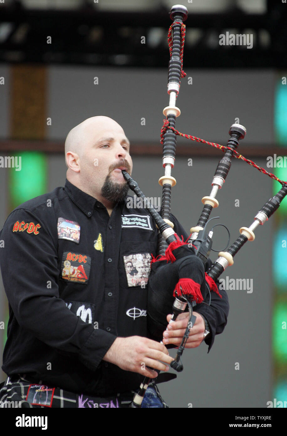 A piper from the Campbell Brothers performs on Parliament Hill in ...
