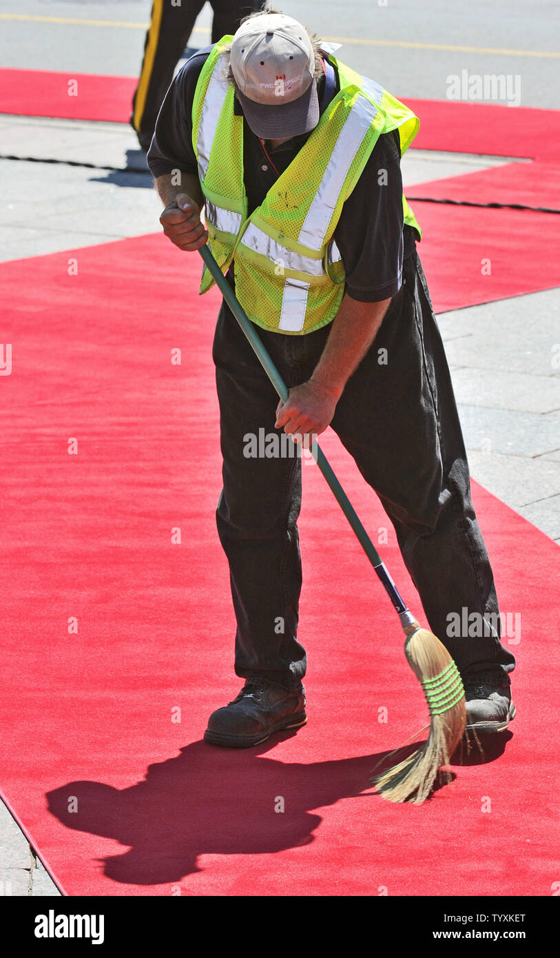 Grounds crew sweep the red carpet in preparation for Prince William and ...