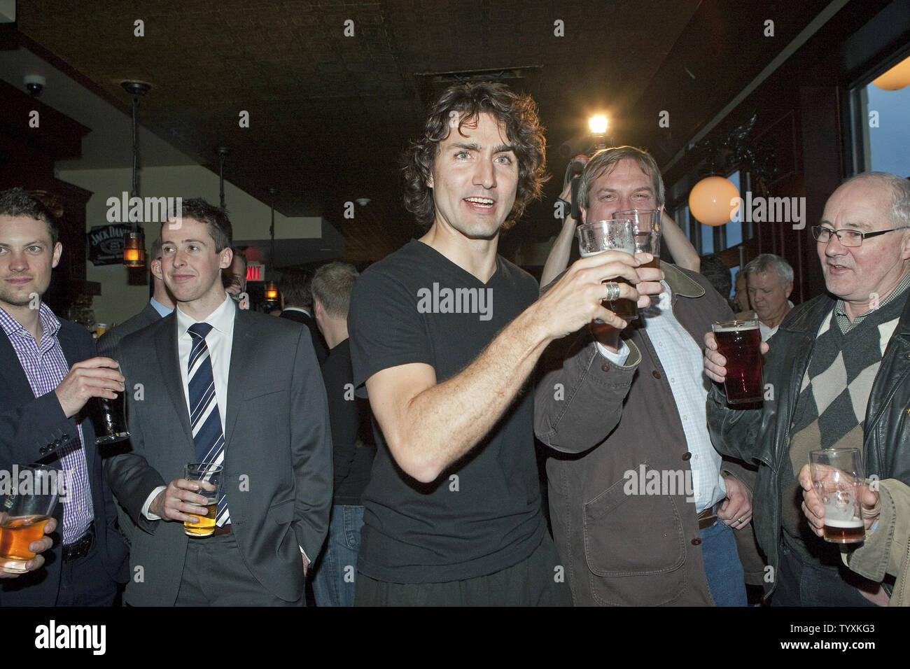 Liberal Member of Parliament Justin Trudeau shares a beer with patrons ...
