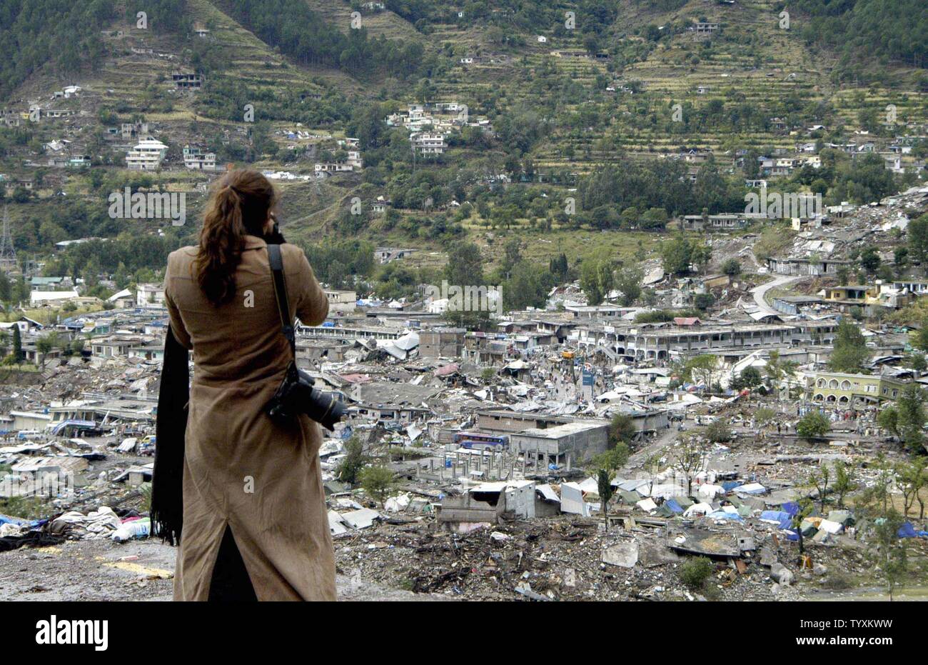 An Iranian photographer, Newsha Tavakkolian, stands in front of large ...