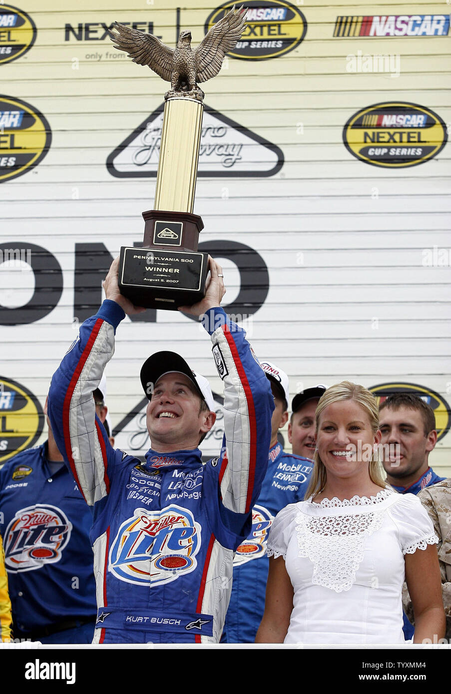 Kurt Busch holds up the winners trophy standing next to his wife Eva ...