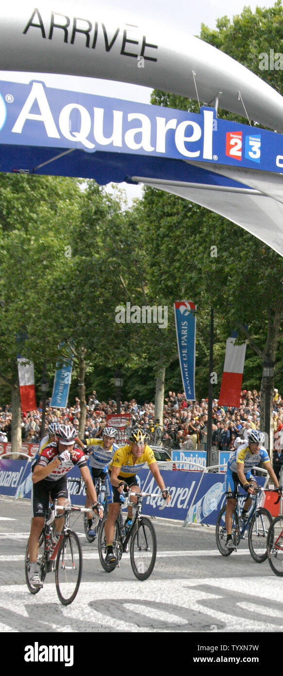 American Lance Armstrong in the yellow jersey crosses the finish line ...