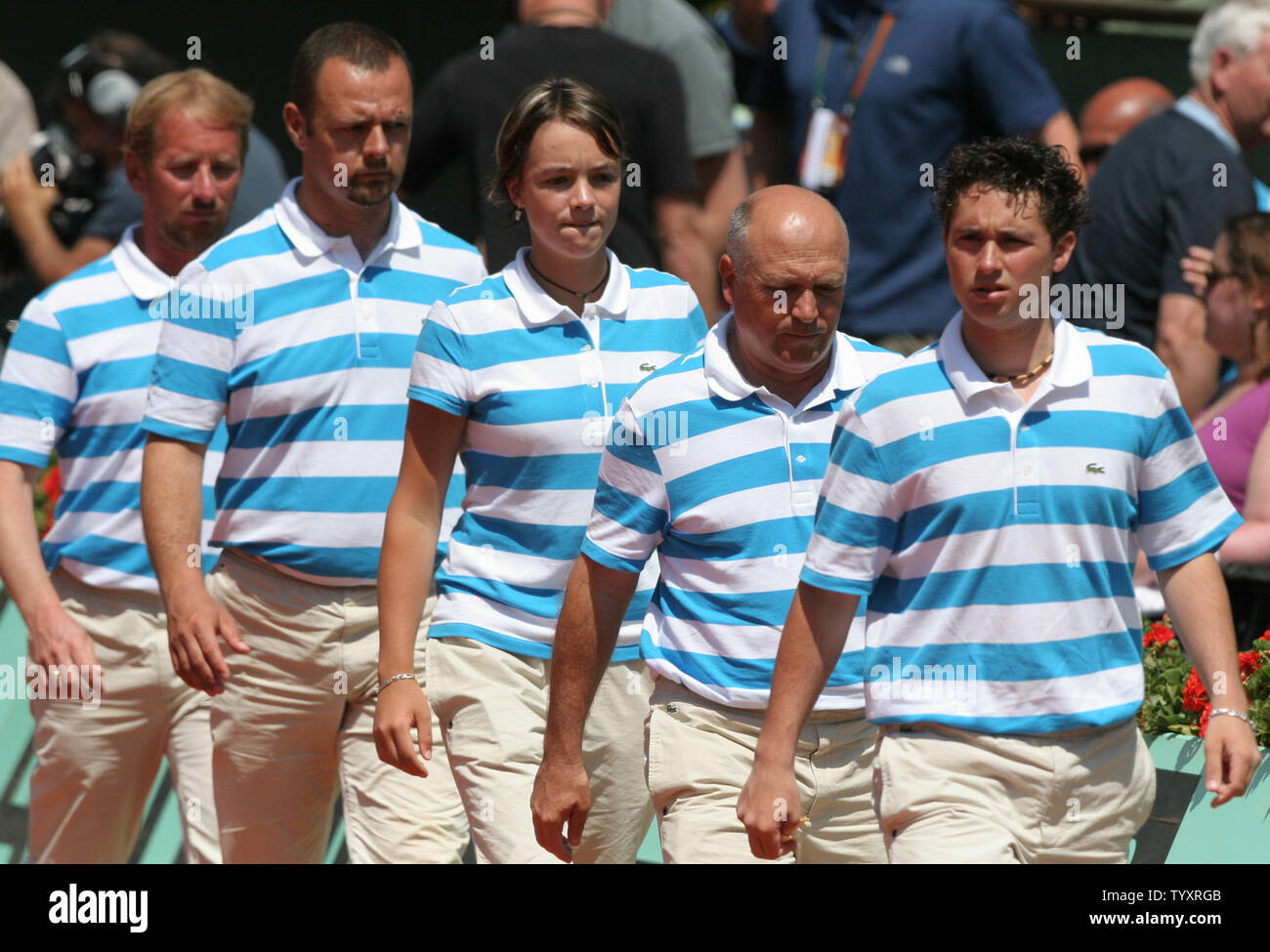 Line judges enter the court before a match at the French Open at Roland ...
