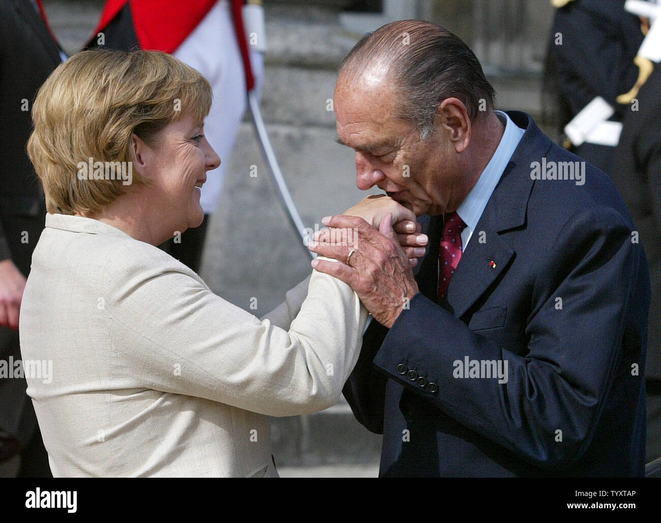 French President Jacques Chirac (R) kisses the hand of German ...