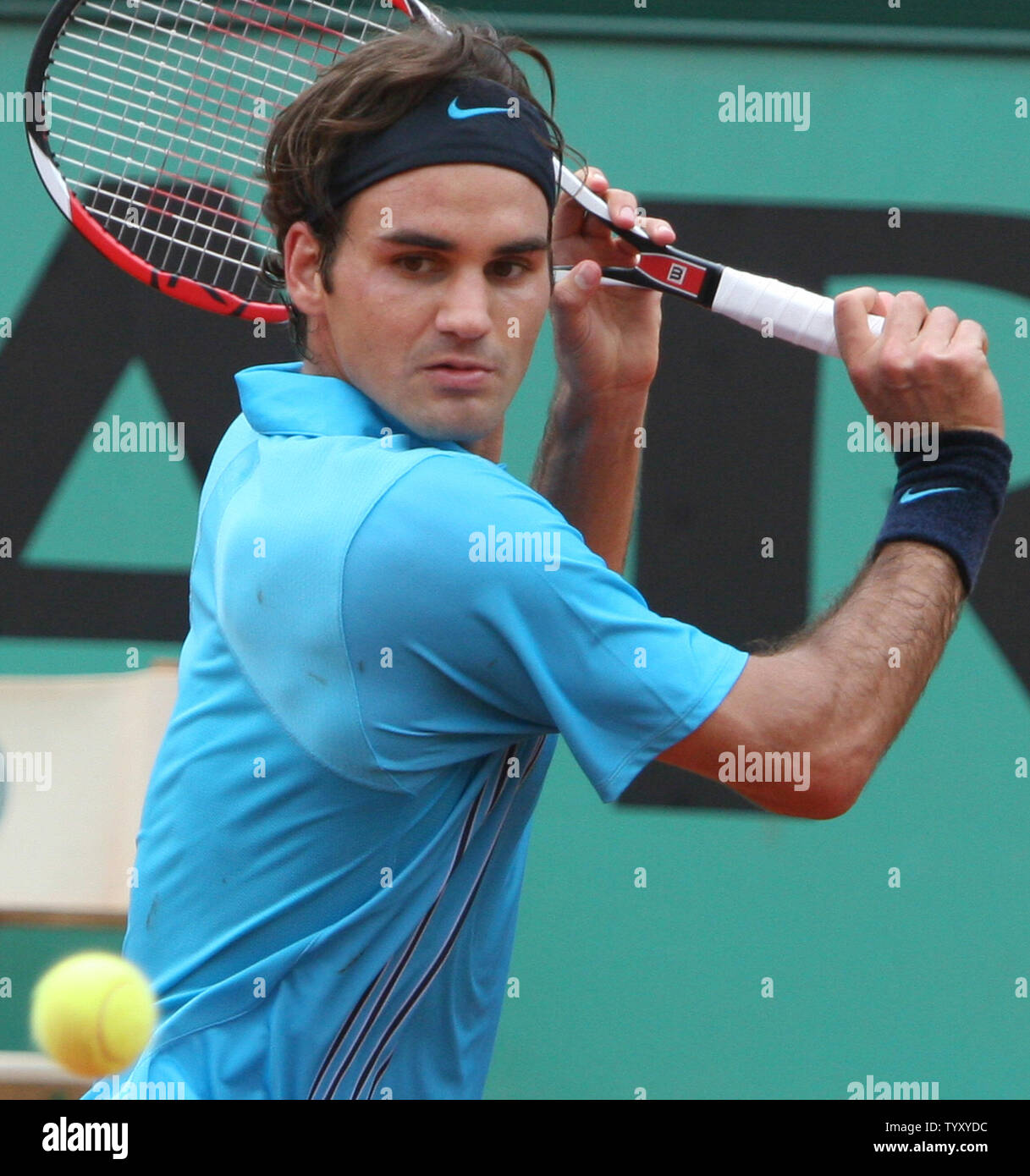 Roger Federer of Switzerland prepares a backhand during his semi-final ...